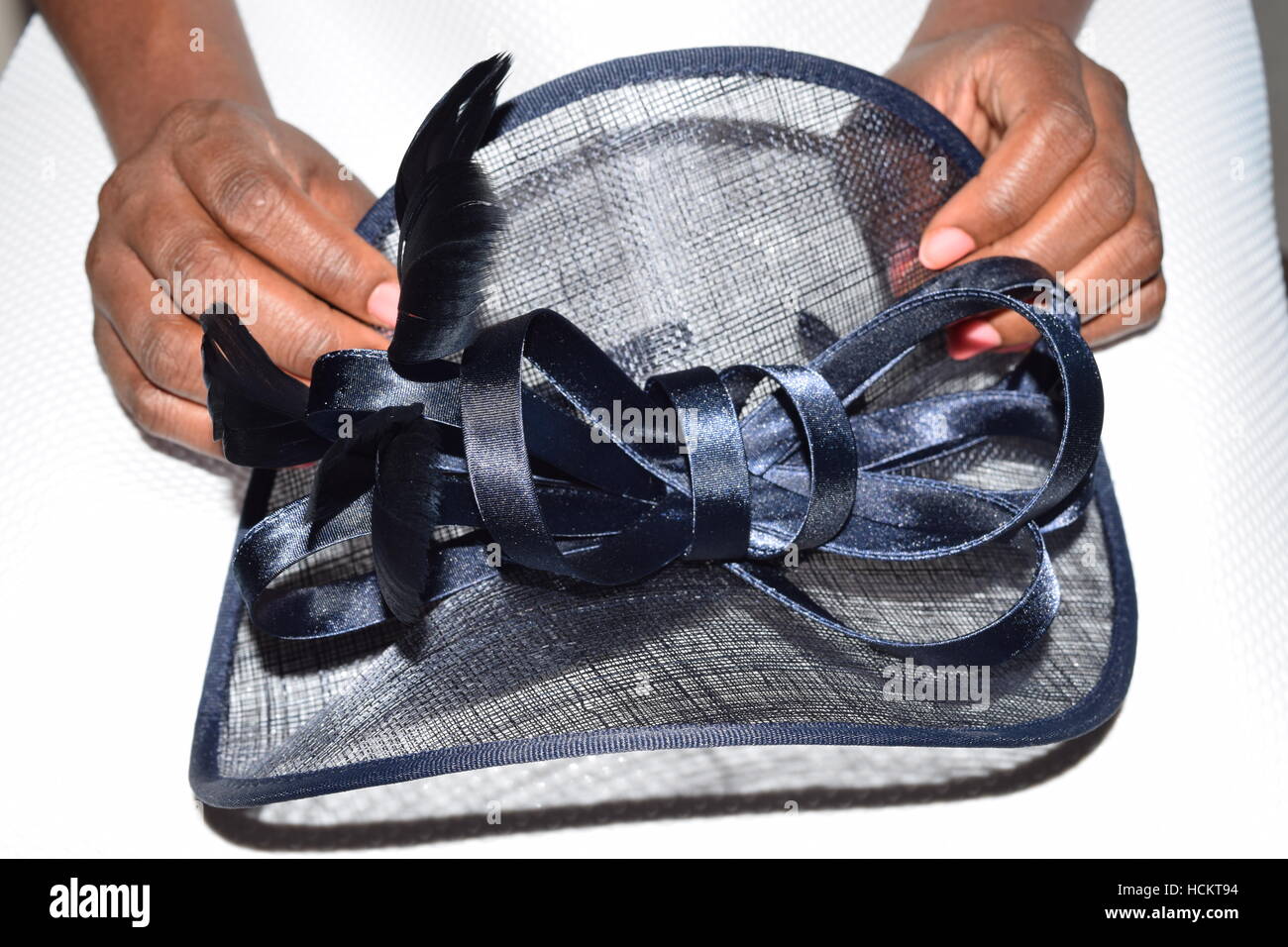 Female hands clutching Royal Ascot against a white background Stock ...