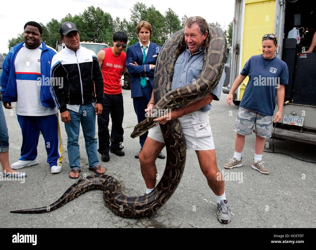 SNAKES ON A PLANE, Bruce James (center, back, in blue blazer), snake ...