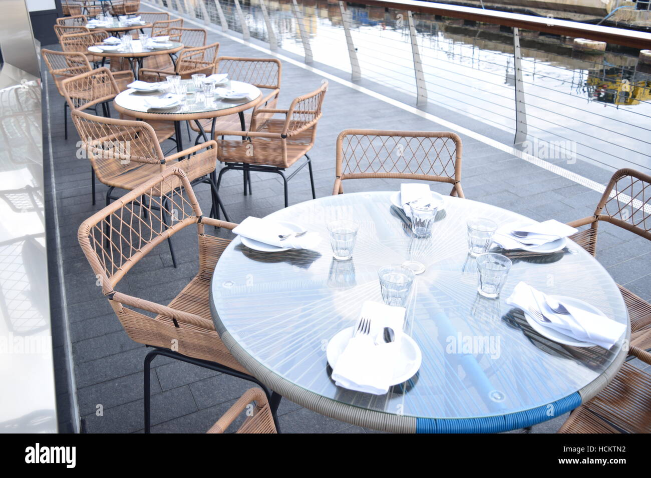Long row of outdoor tables at a restaurant on a bridge overlooking the ...