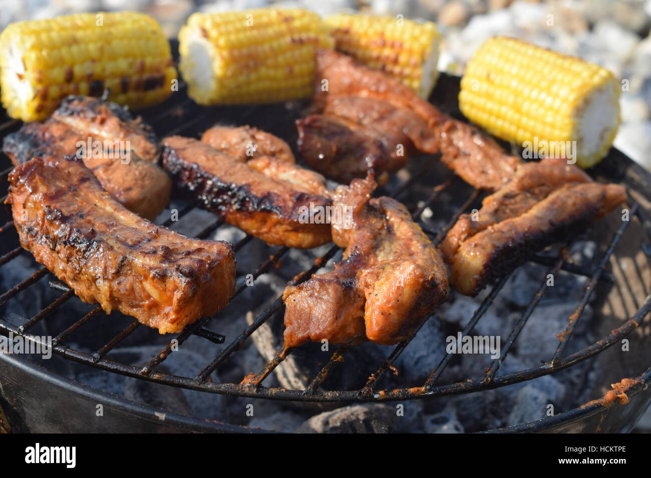 Cooked crispy ribs on an outdoor barbecue Stock Photo - Alamy