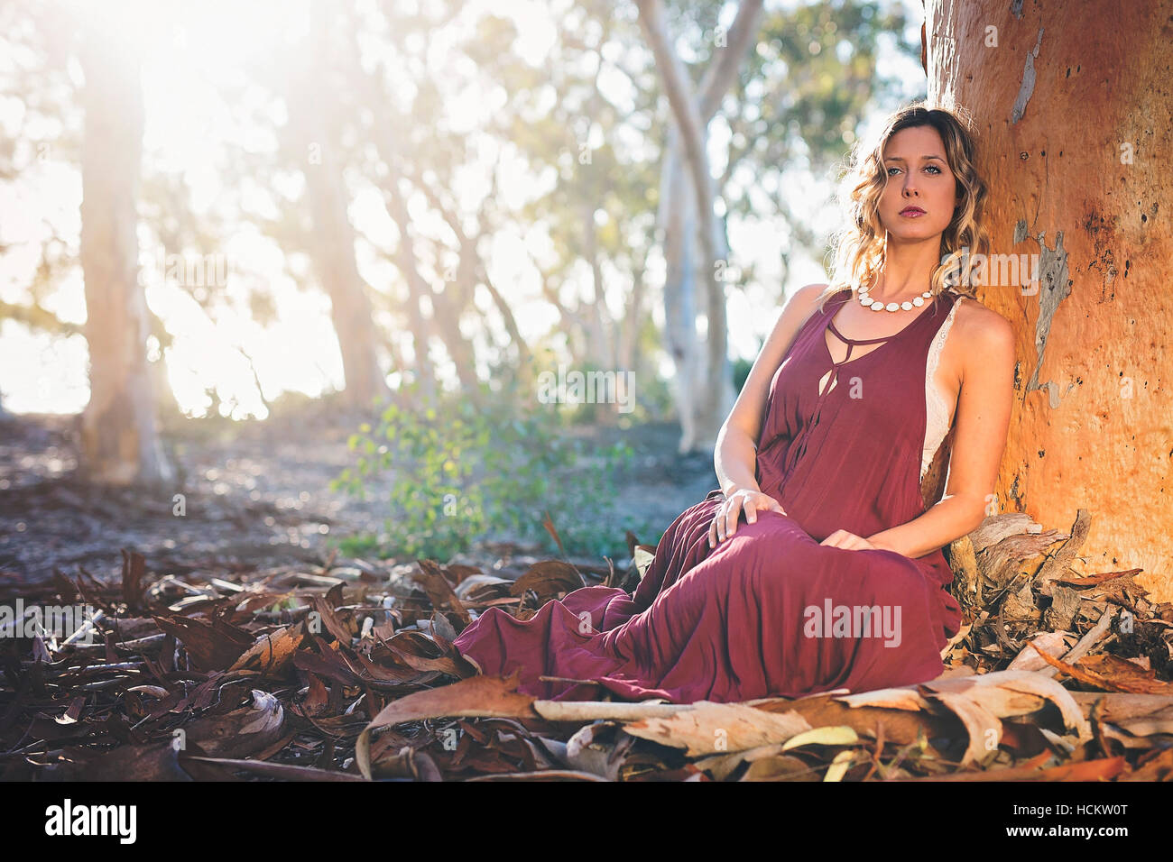Woman next to tree Stock Photo - Alamy