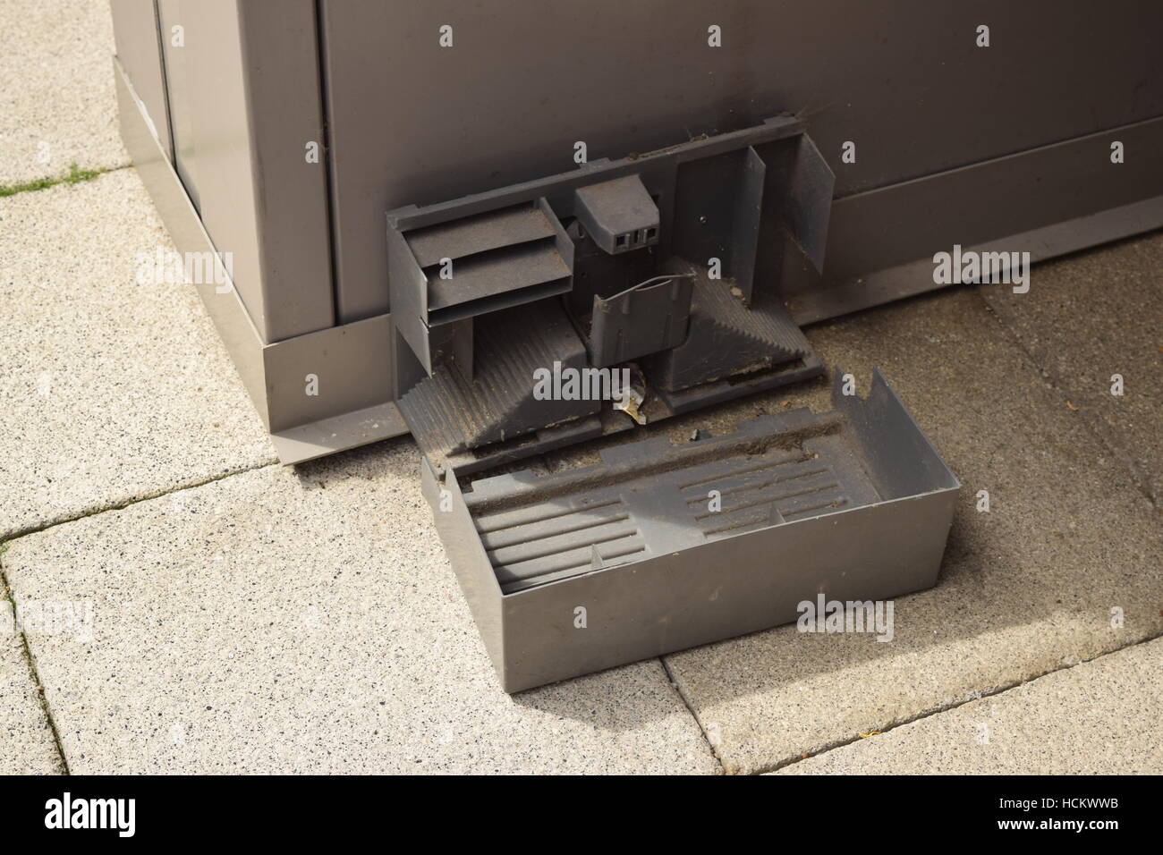 Small broken metal built rat trap against a wall in the city Stock ...