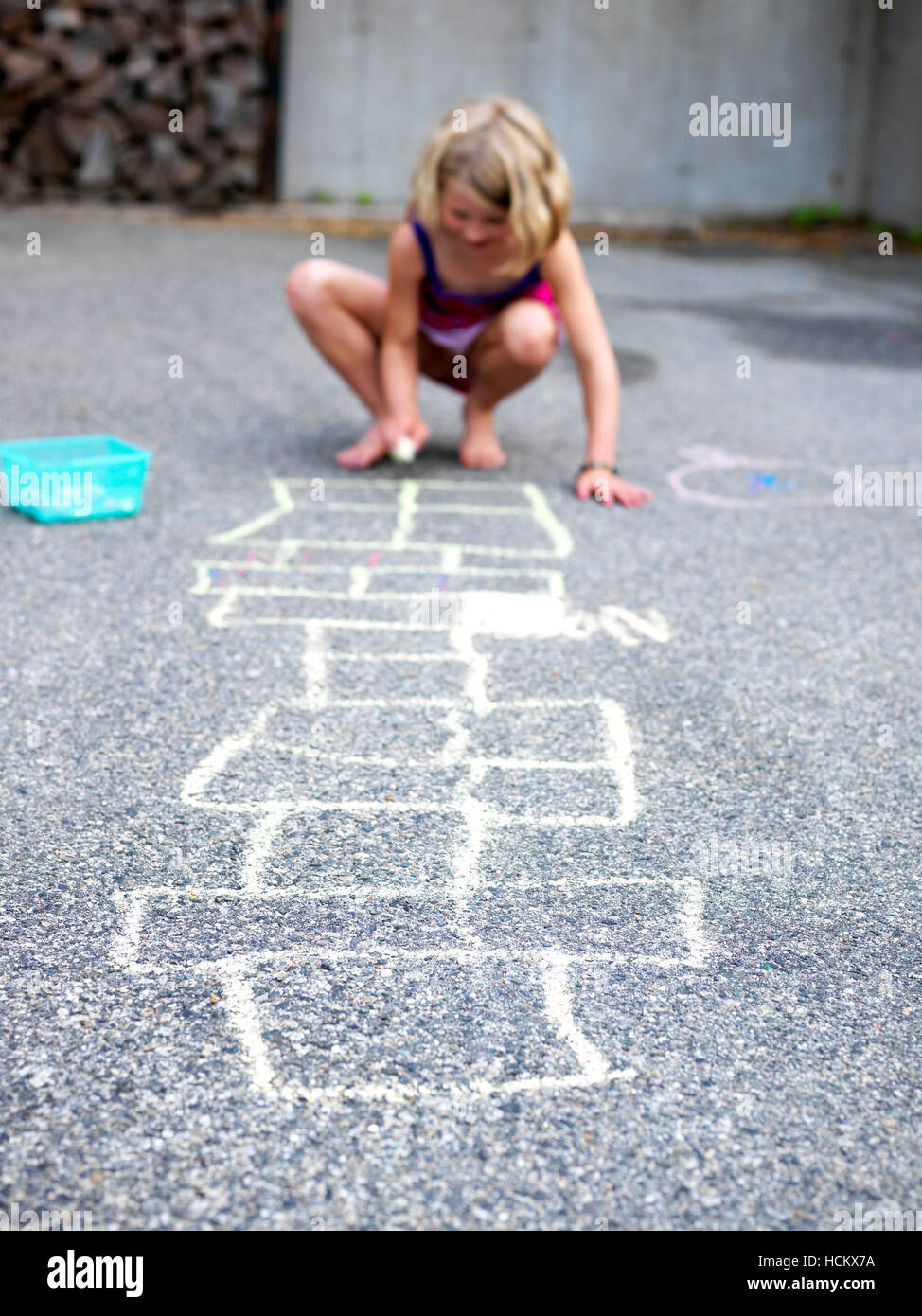 Girl making her own version of a hopscotch course Stock Photo - Alamy