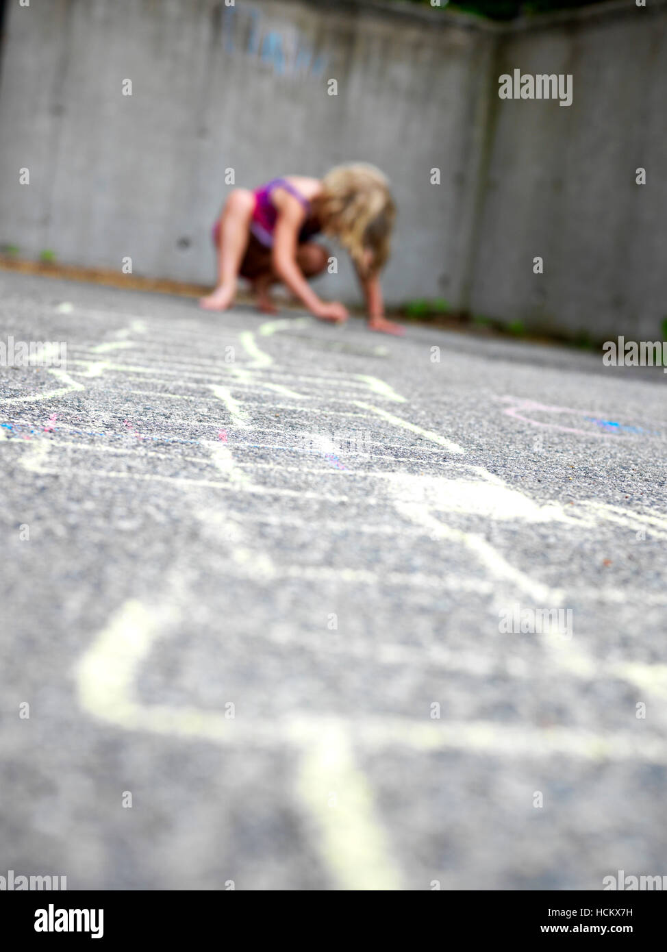 Girl making her own version of a hopscotch course Stock Photo - Alamy