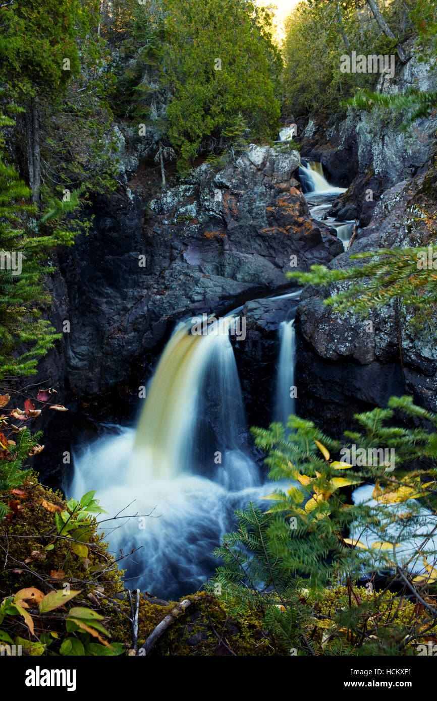 Silky water flows over the falls in Cascade River State Park, Minnesota ...