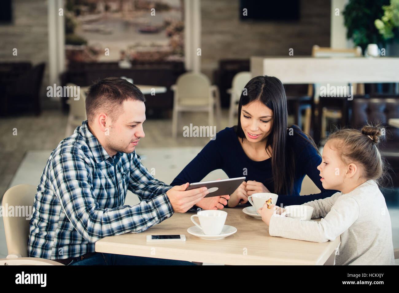 Family enjoying tea in cafe hi-res stock photography and images - Alamy