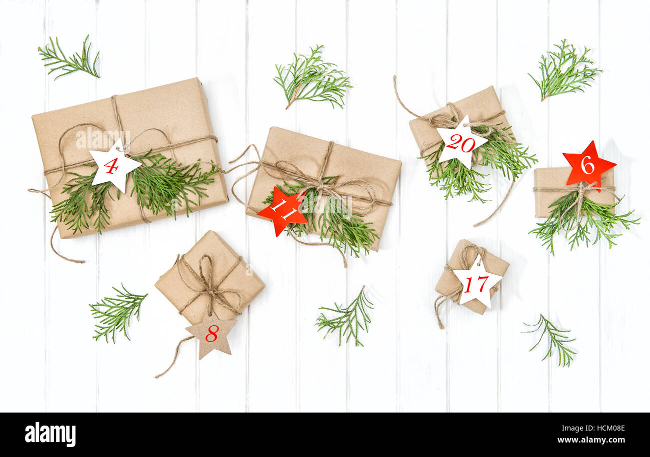 Gifts Advent calendar with christmas tree branches decoration on bright ...
