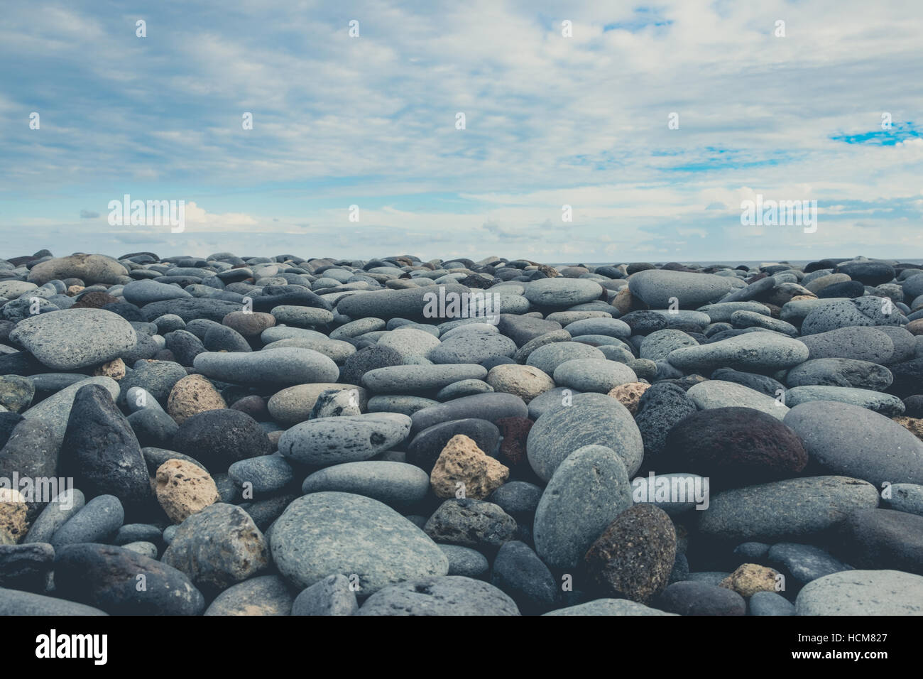 pebble stones, rocks and blue sky horizon Stock Photo - Alamy