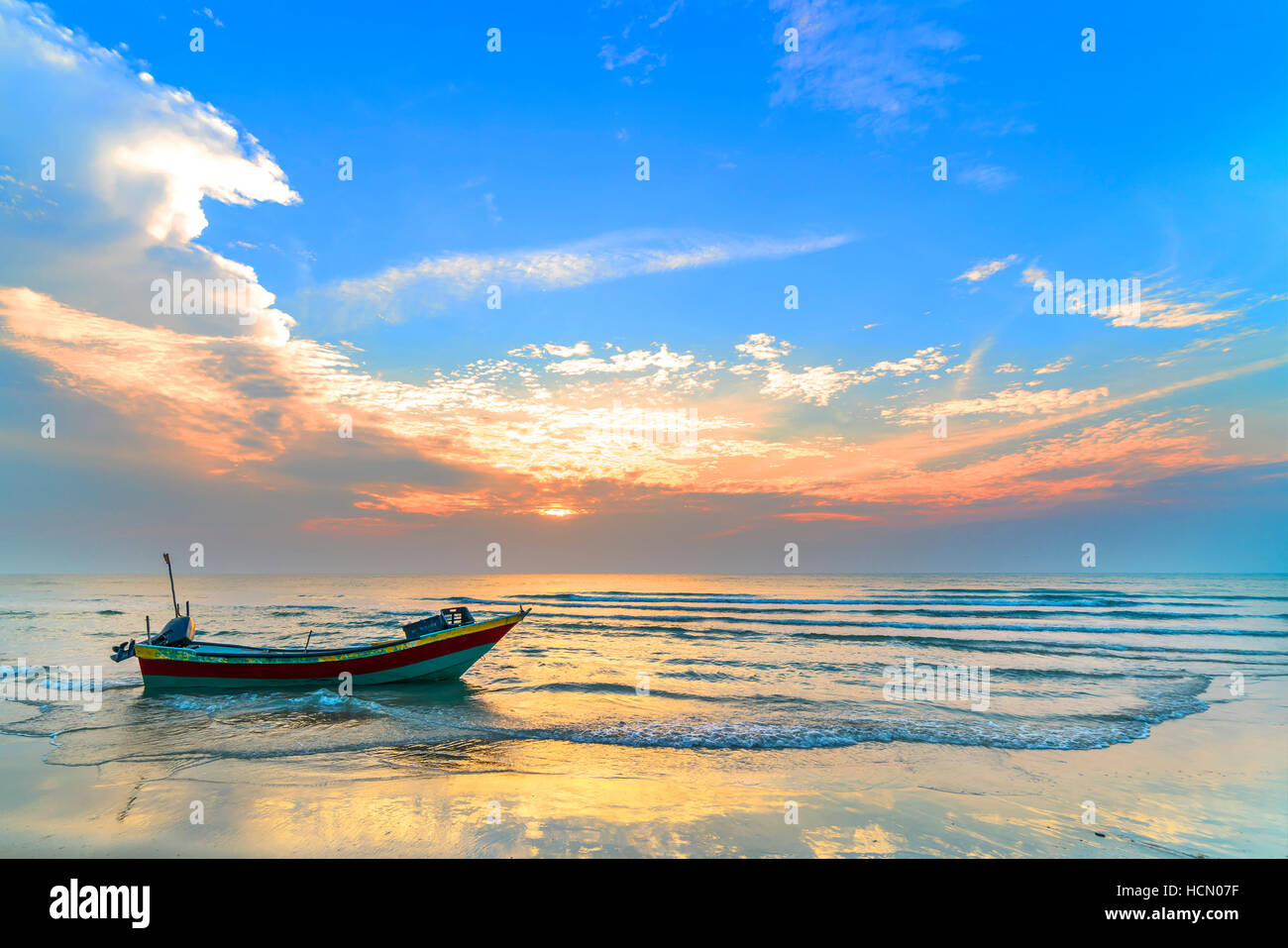 Traditional wooden boat with sunrise background Stock Photo - Alamy