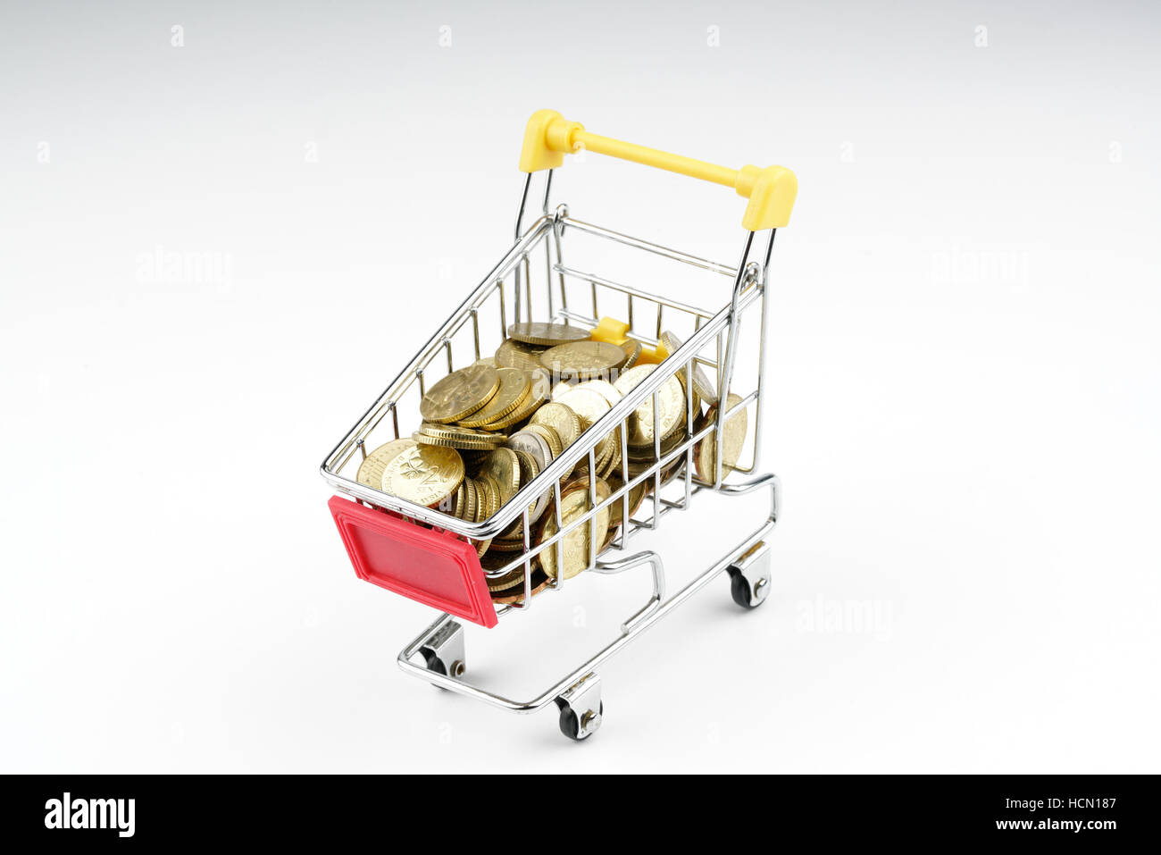 Toy trolley and coin with white background. Financial concept Stock ...