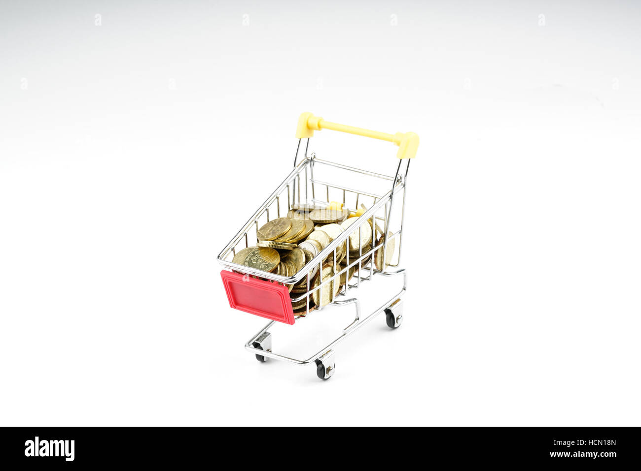Toy trolley and coin with white background. Financial concept Stock ...