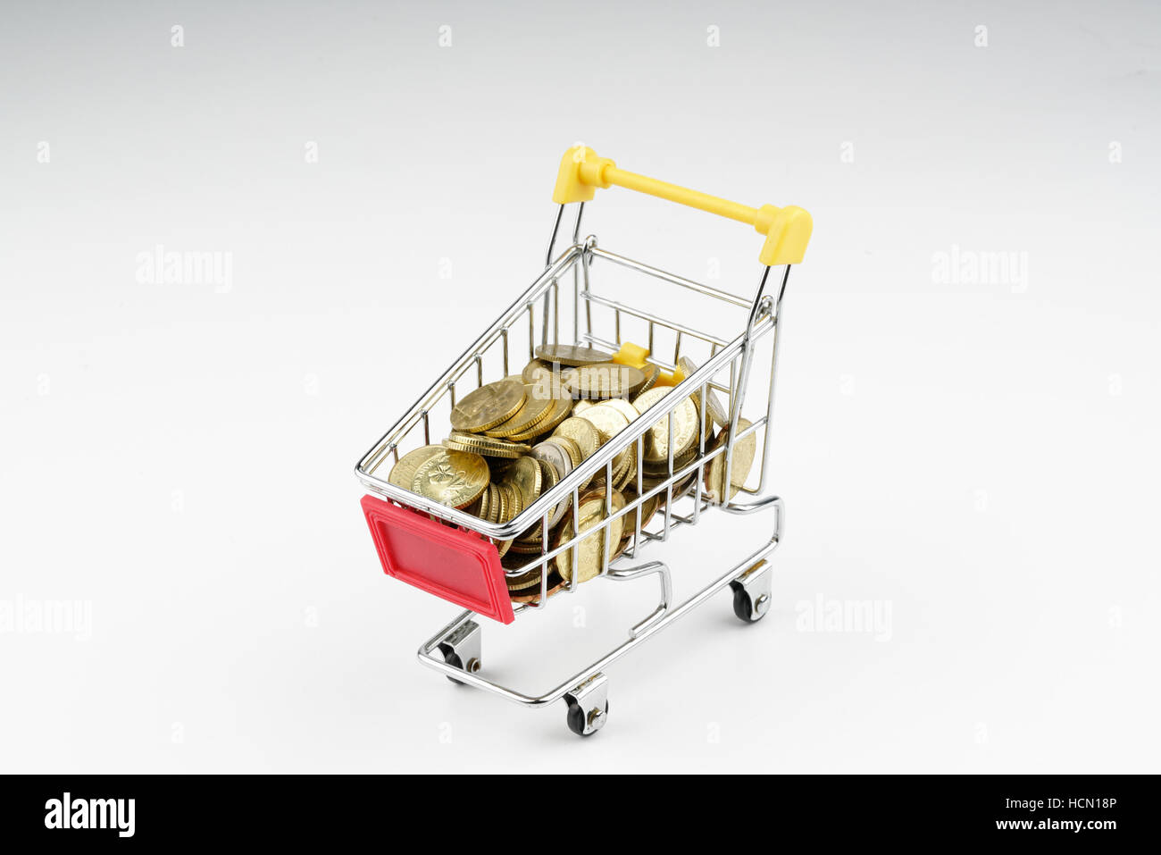 Toy trolley and coin with white background. Financial concept Stock ...