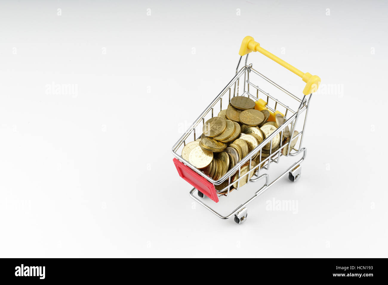 Toy trolley and coin with white background. Financial concept Stock ...