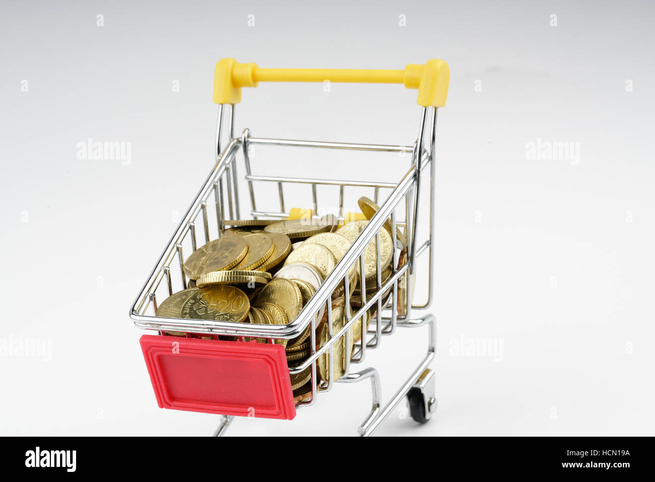 Toy trolley and coin with white background. Financial concept Stock ...