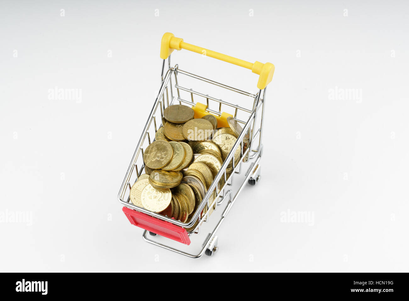 Toy trolley and coin with white background. Financial concept Stock ...