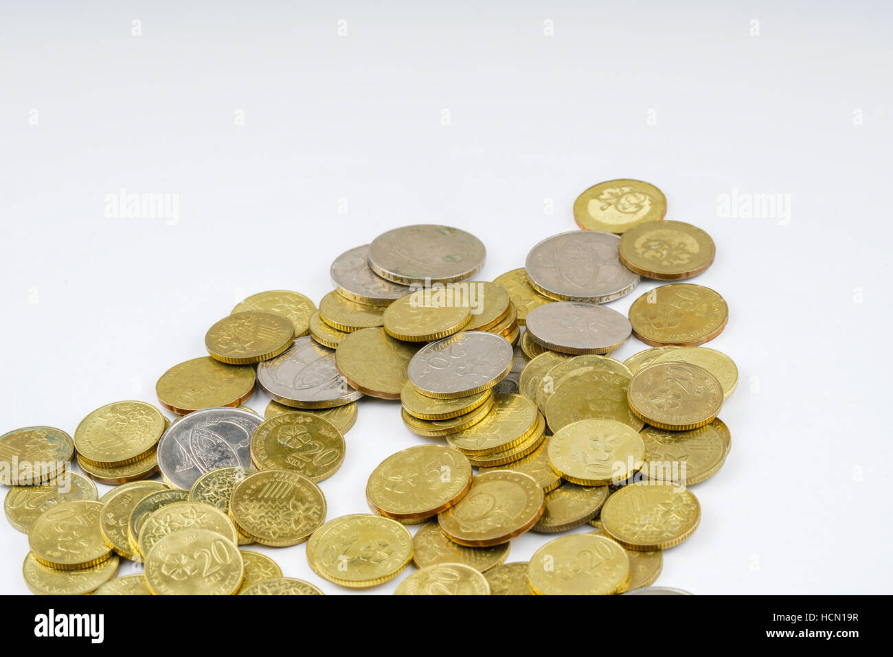 Yellow coins with white background Stock Photo - Alamy