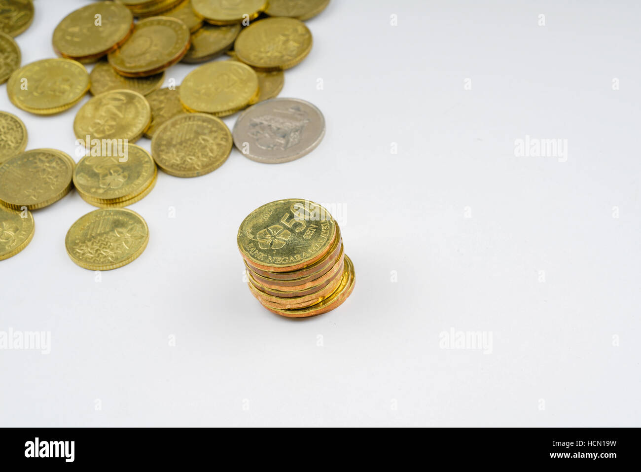 Yellow coins with white background Stock Photo - Alamy