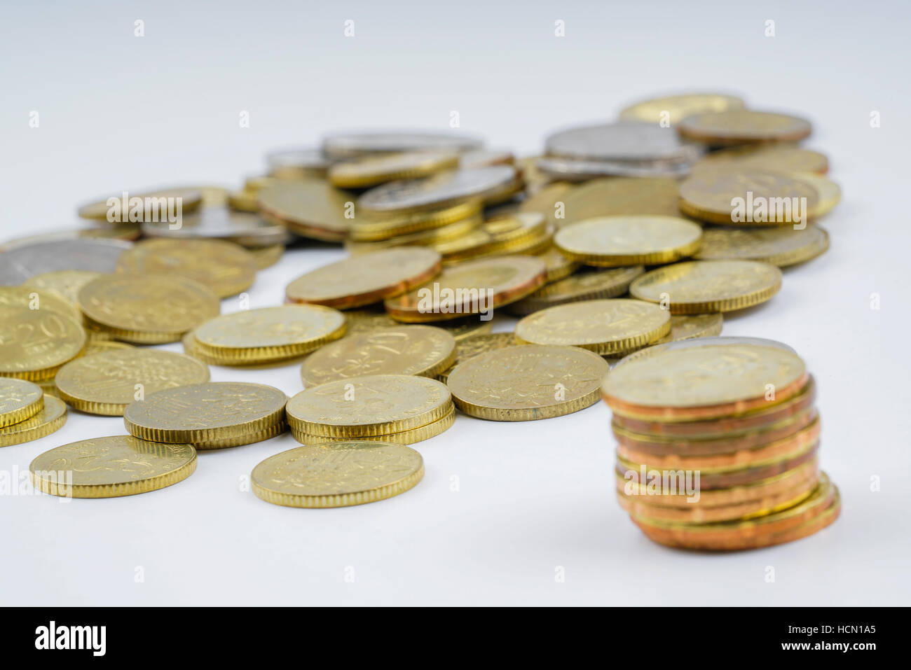 Yellow coins with white background Stock Photo - Alamy