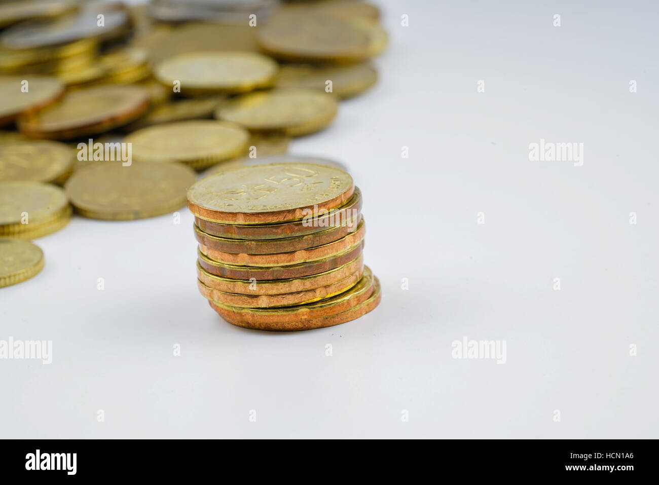 Yellow coins with white background Stock Photo - Alamy