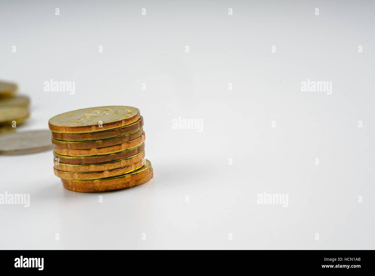 Yellow coins with white background Stock Photo - Alamy