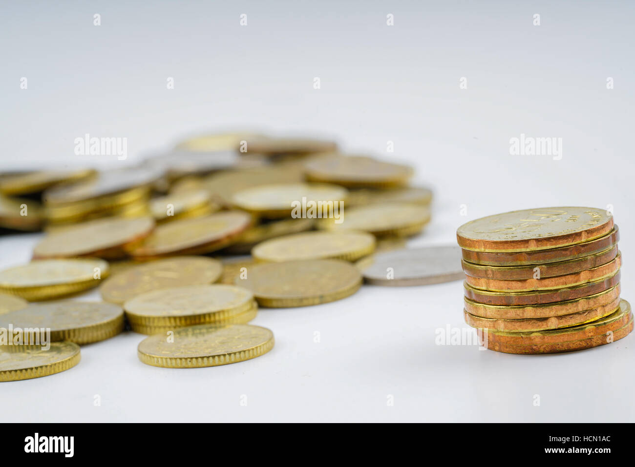Yellow coins with white background Stock Photo - Alamy