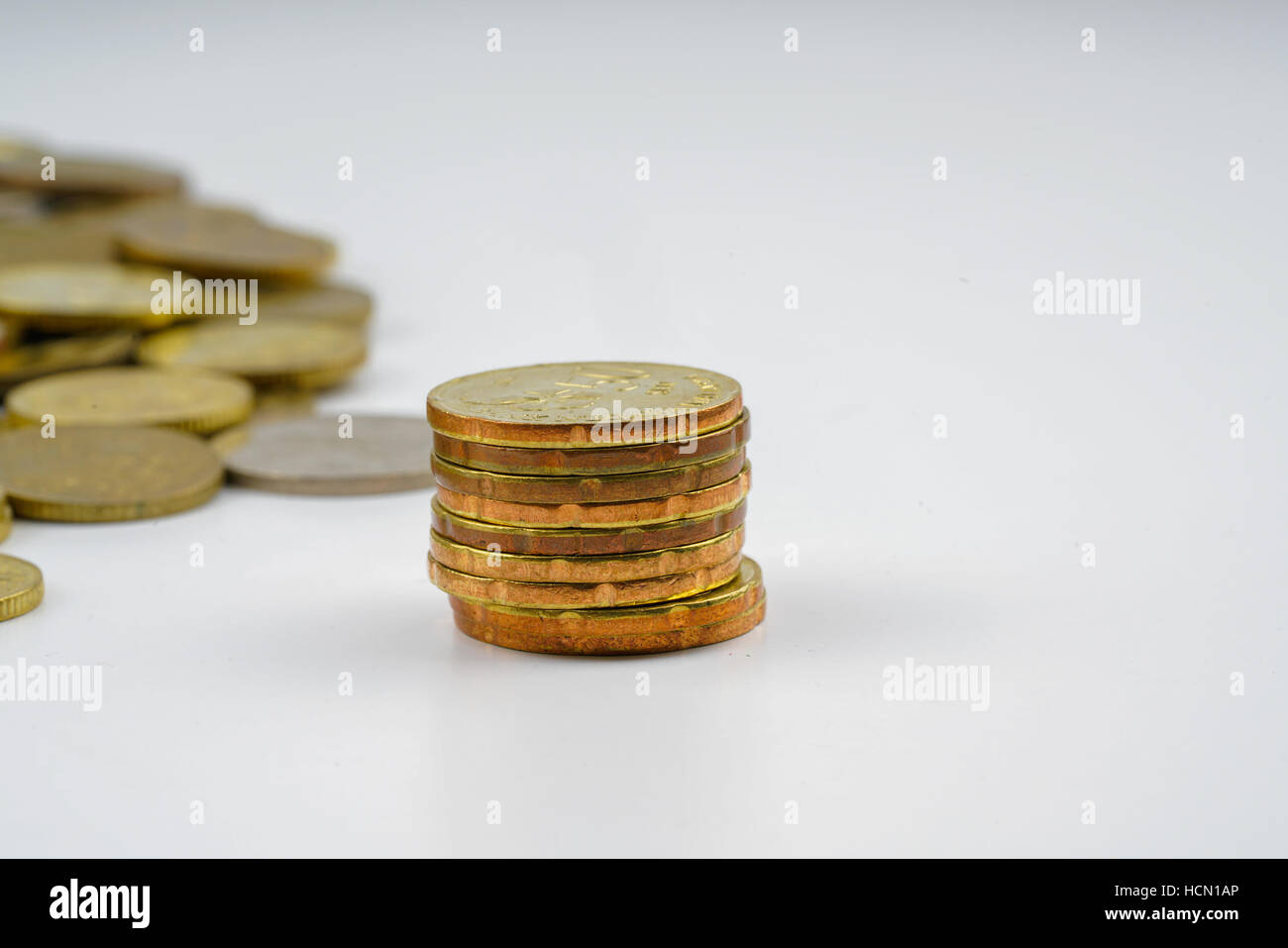 Yellow coins with white background Stock Photo - Alamy