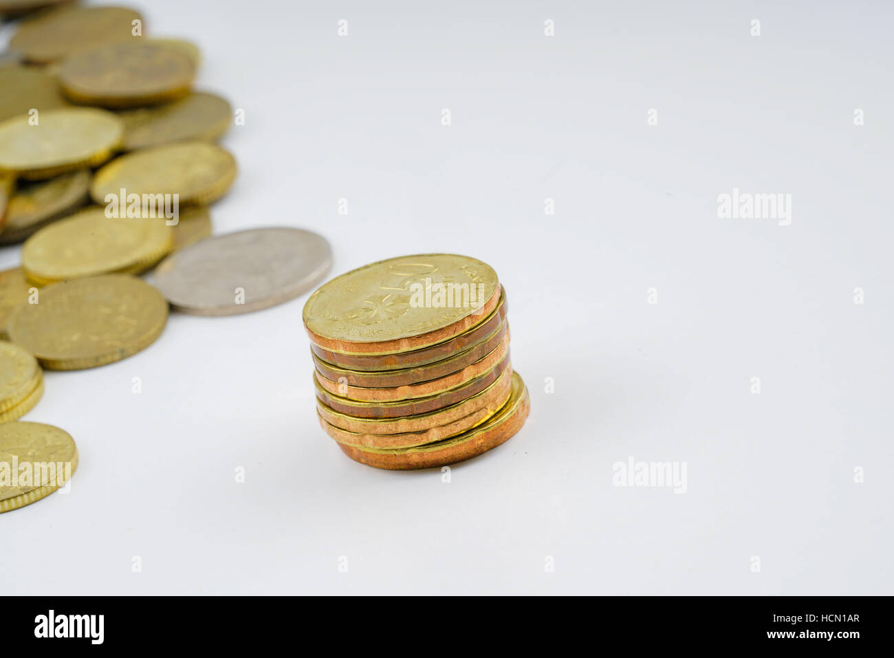Yellow coins with white background Stock Photo - Alamy