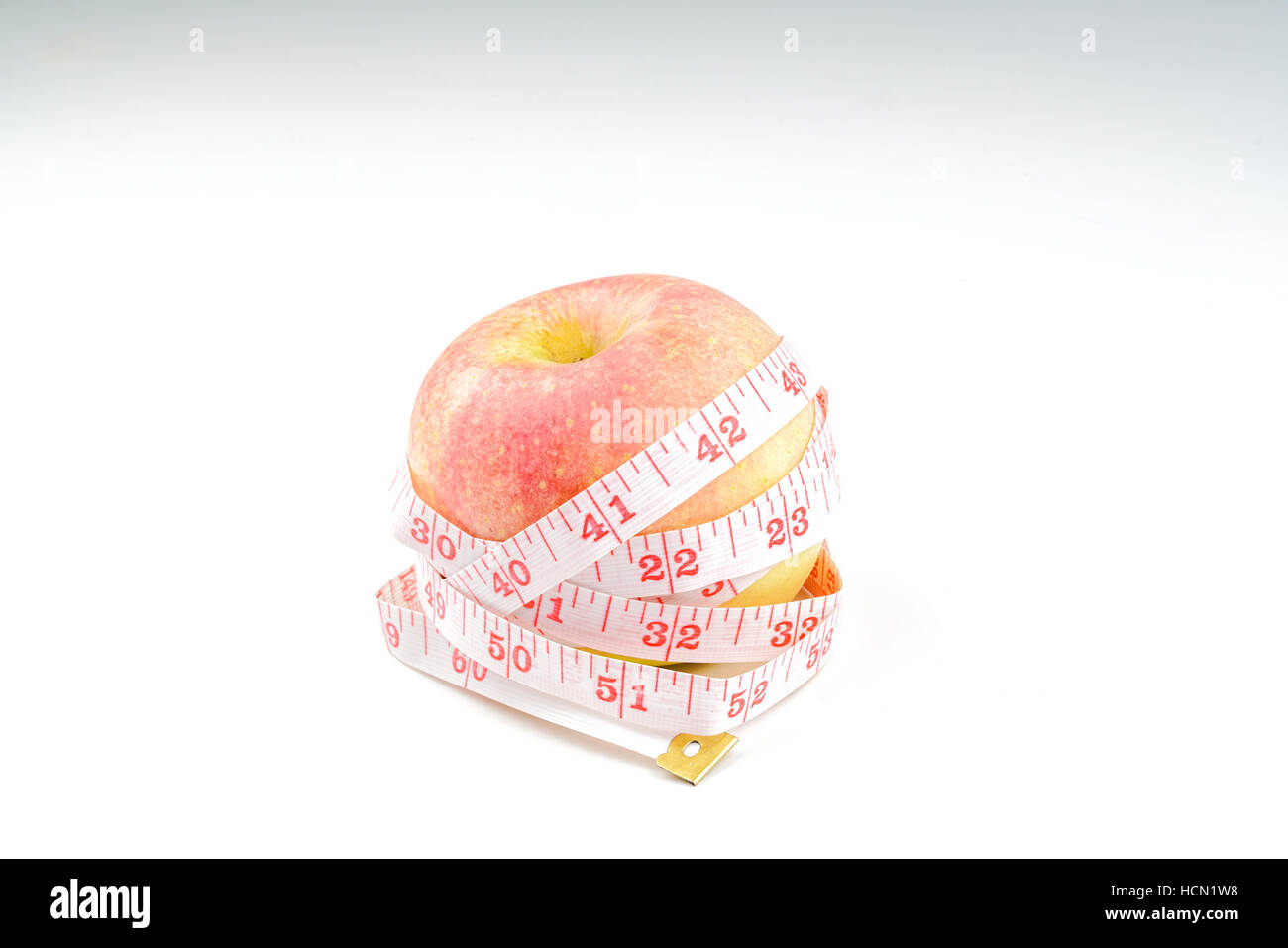 Red apple with measure tape Stock Photo - Alamy