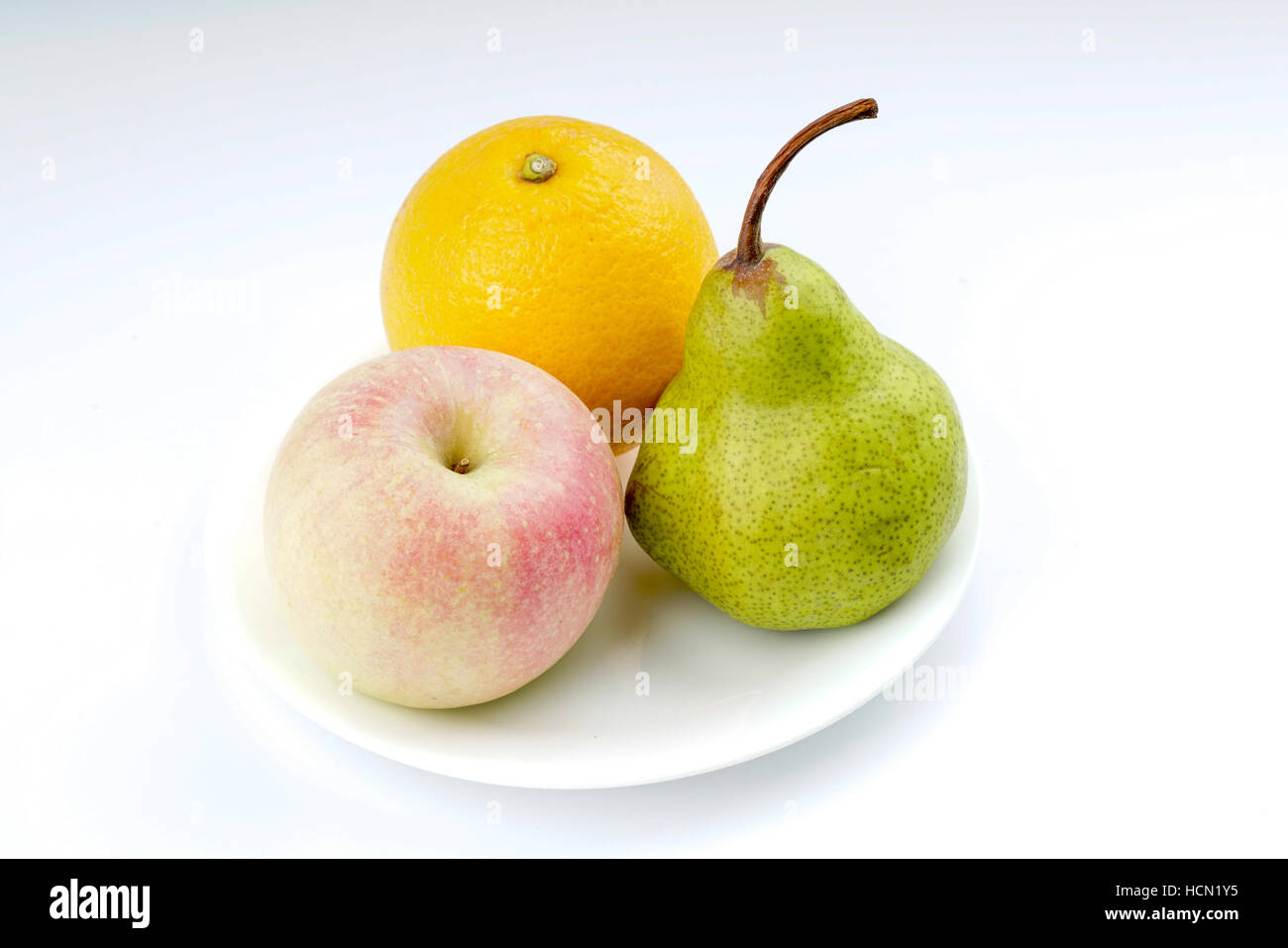 Pear, orange and red apple Stock Photo - Alamy