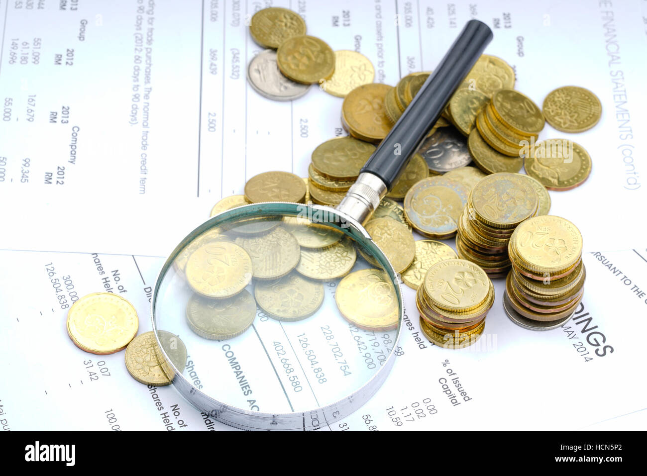 Coins with bill statement Stock Photo - Alamy