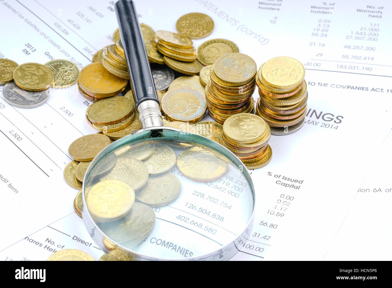 Coins with bill statement Stock Photo - Alamy