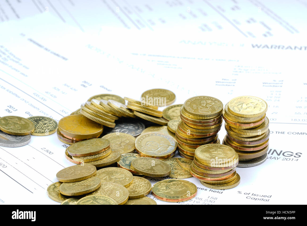 Coins with bill statement Stock Photo - Alamy
