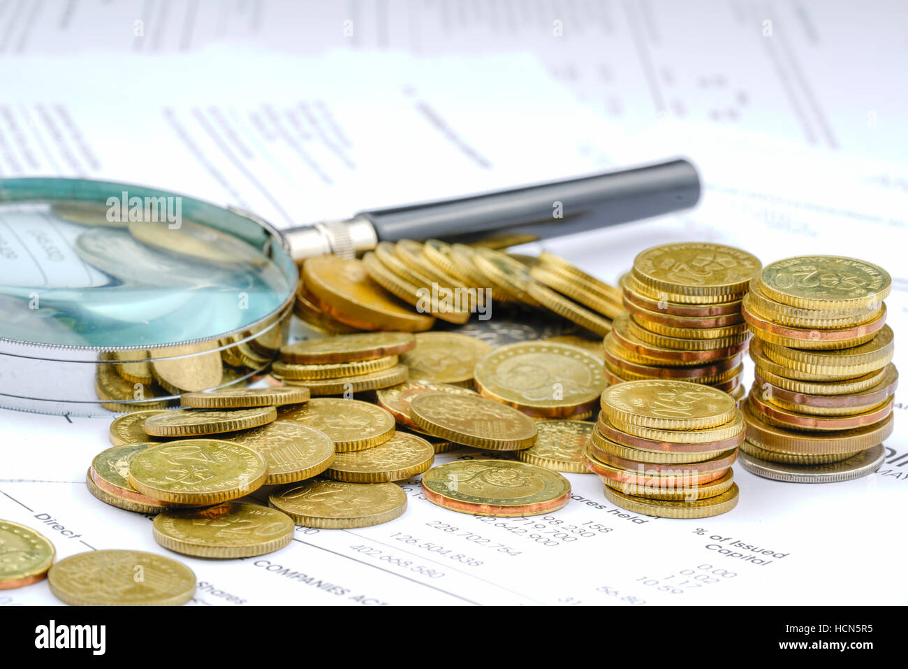Coins with bill statement Stock Photo - Alamy