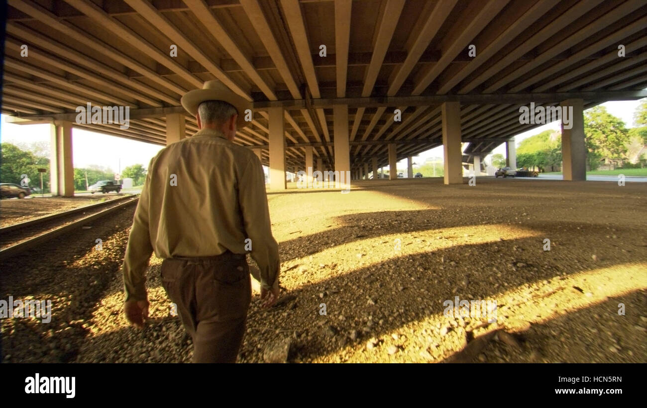 THE UNFORESEEN, Desert prospector walks beneath a highway overpass in ...