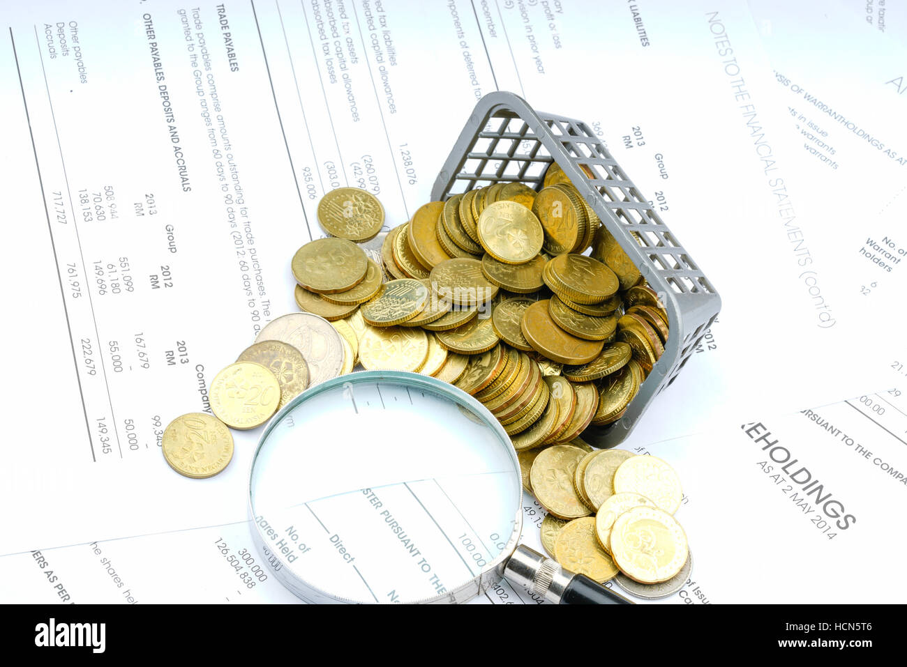 Coins with bill statement Stock Photo - Alamy