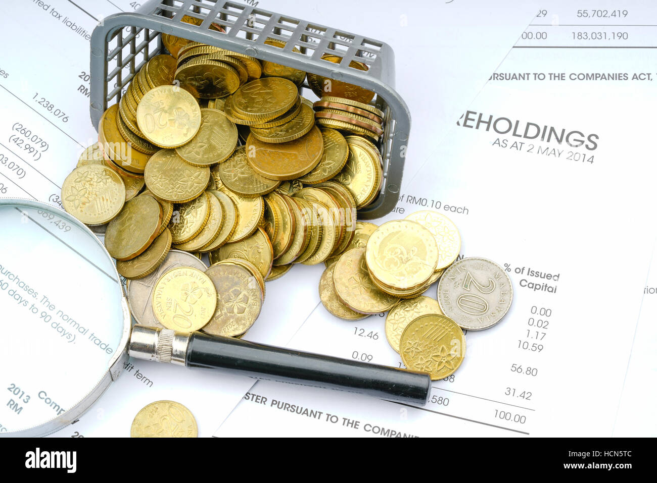 Coins with bill statement Stock Photo - Alamy