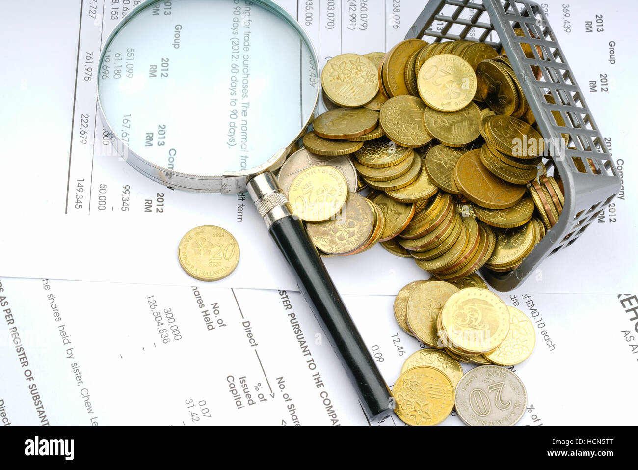 Coins with bill statement Stock Photo - Alamy