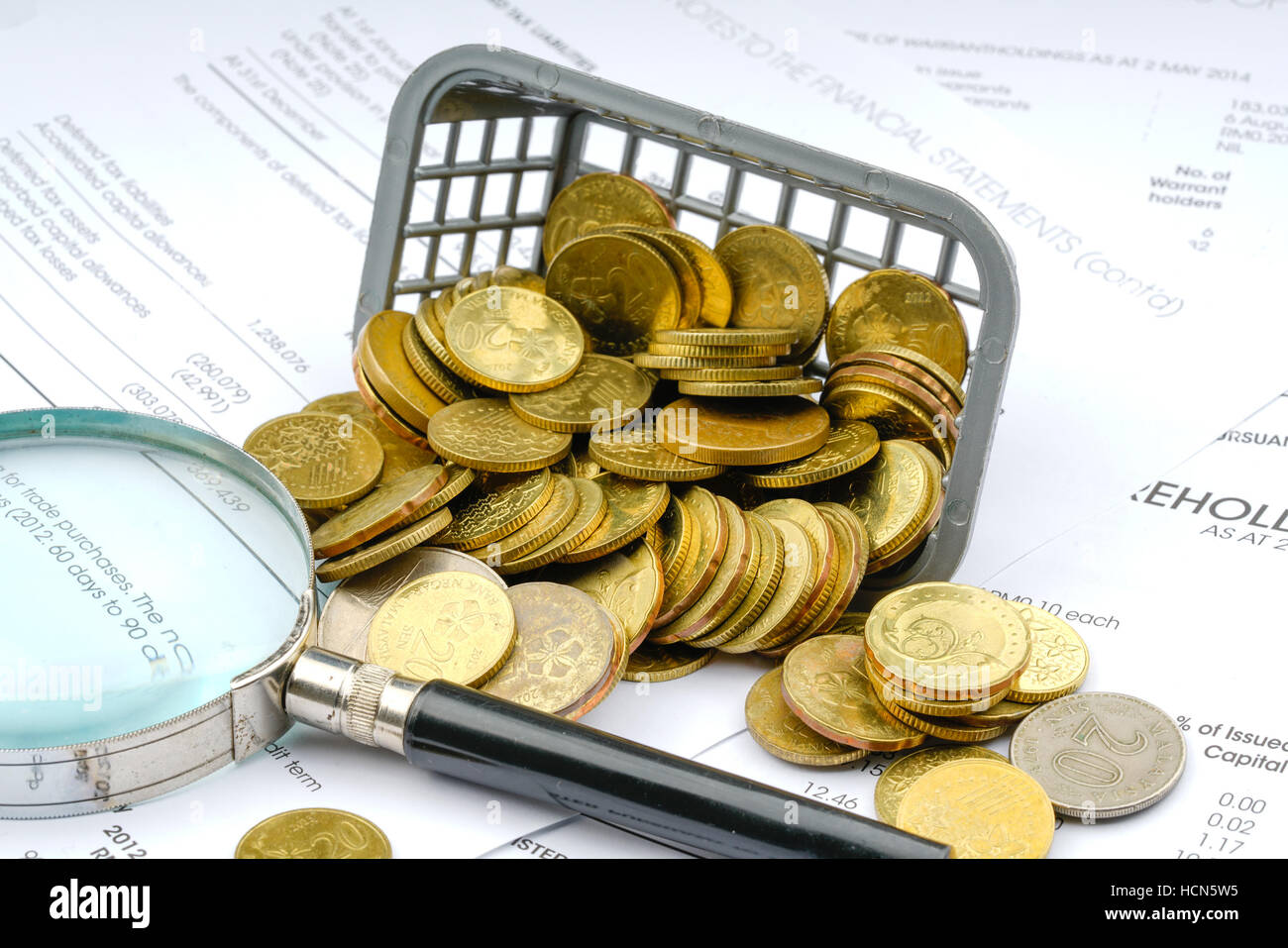 Coins with bill statement Stock Photo - Alamy