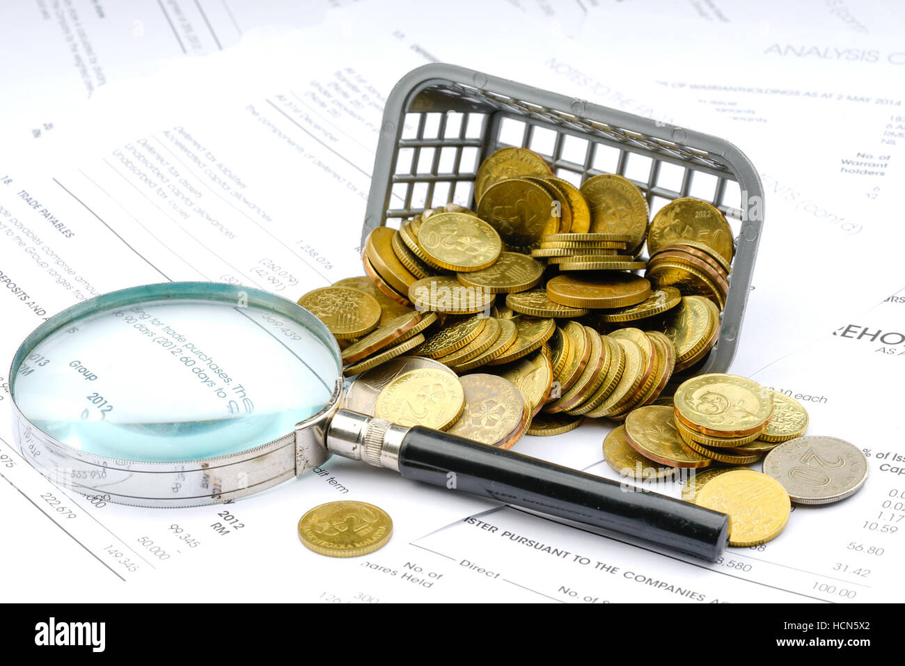 Coins with bill statement Stock Photo - Alamy