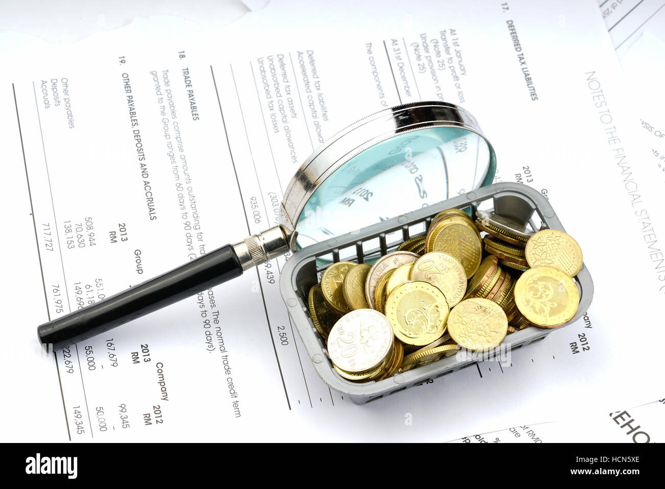Coins with bill statement Stock Photo - Alamy