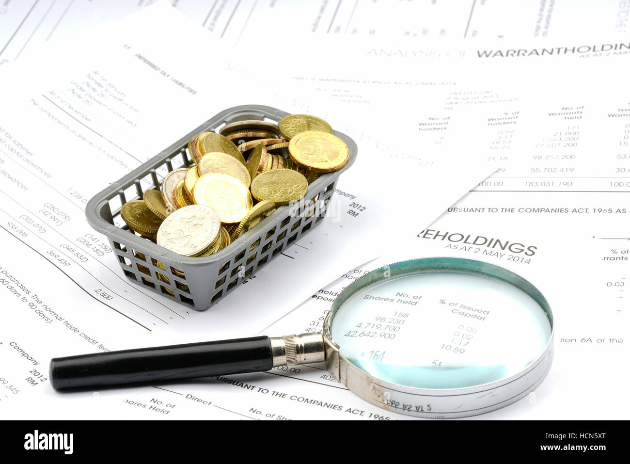 Coins with bill statement Stock Photo - Alamy
