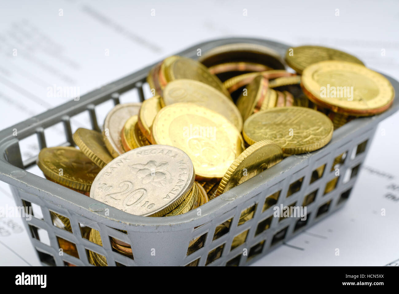 Coins with bill statement Stock Photo - Alamy