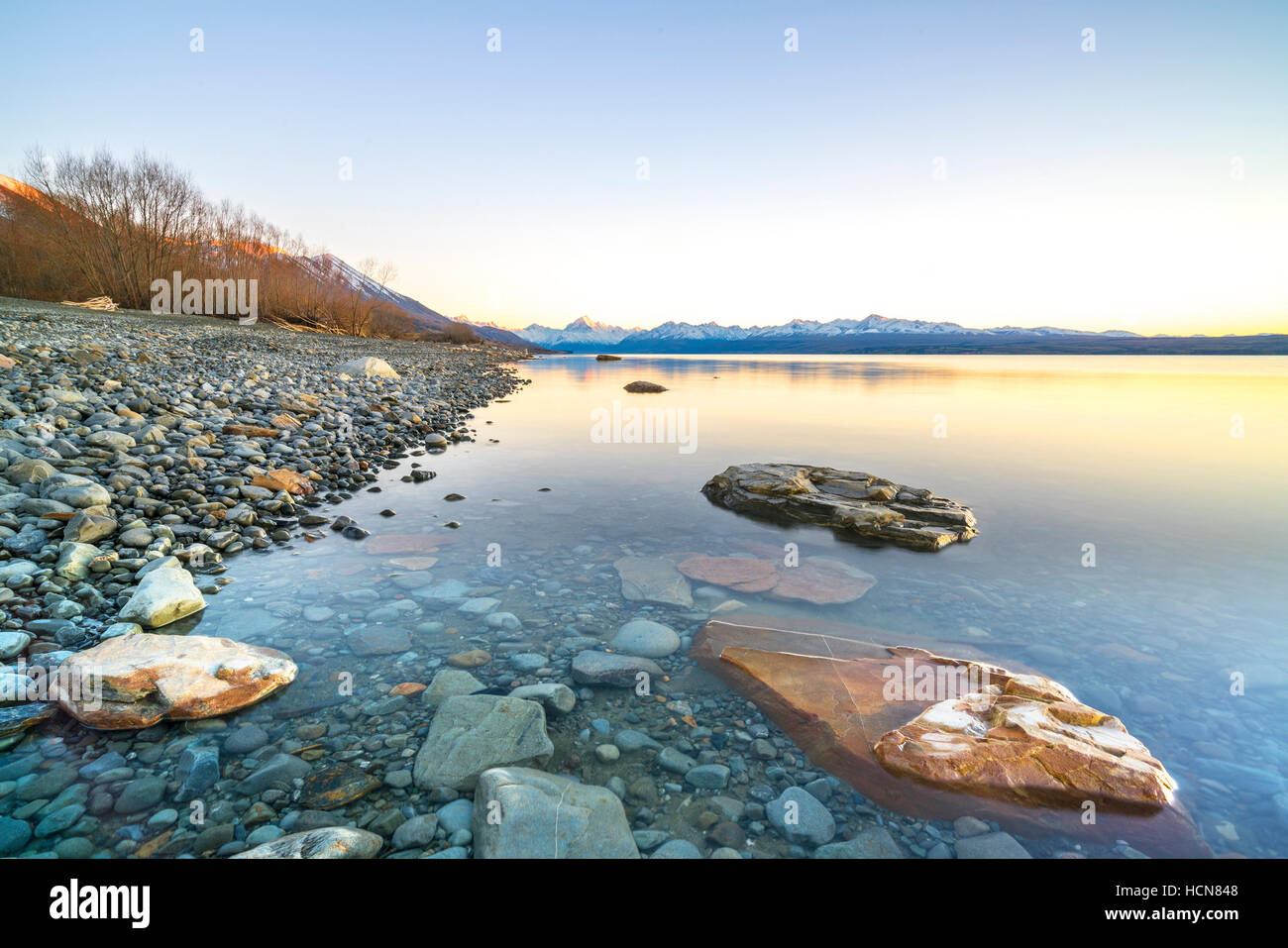 Stone lake with sunrise background Stock Photo - Alamy