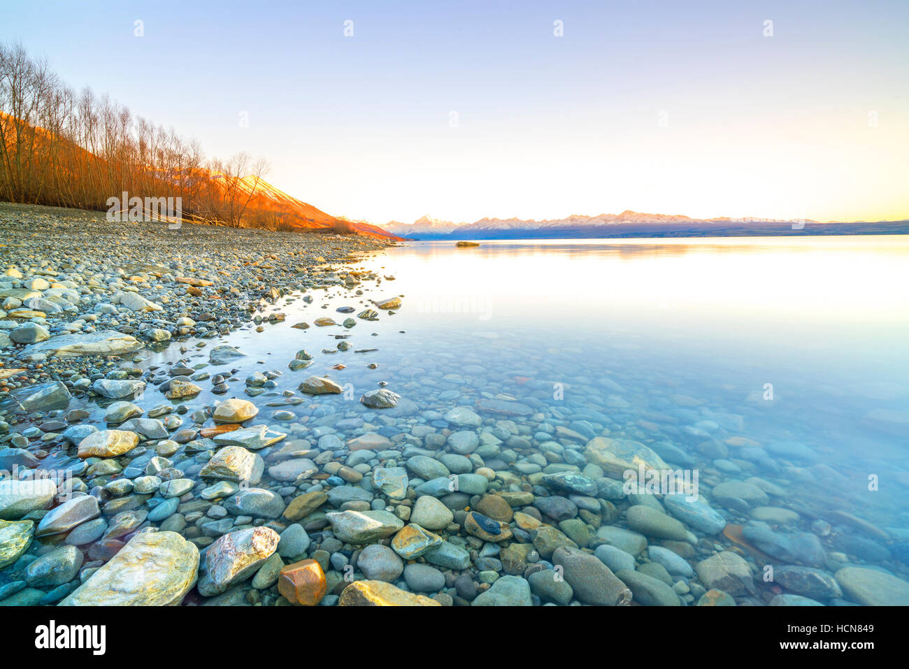 Stone lake with sunrise background Stock Photo - Alamy