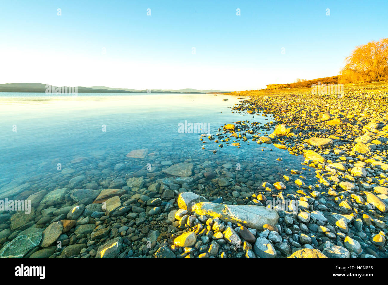 Stone lake with sunrise sunlight Stock Photo - Alamy