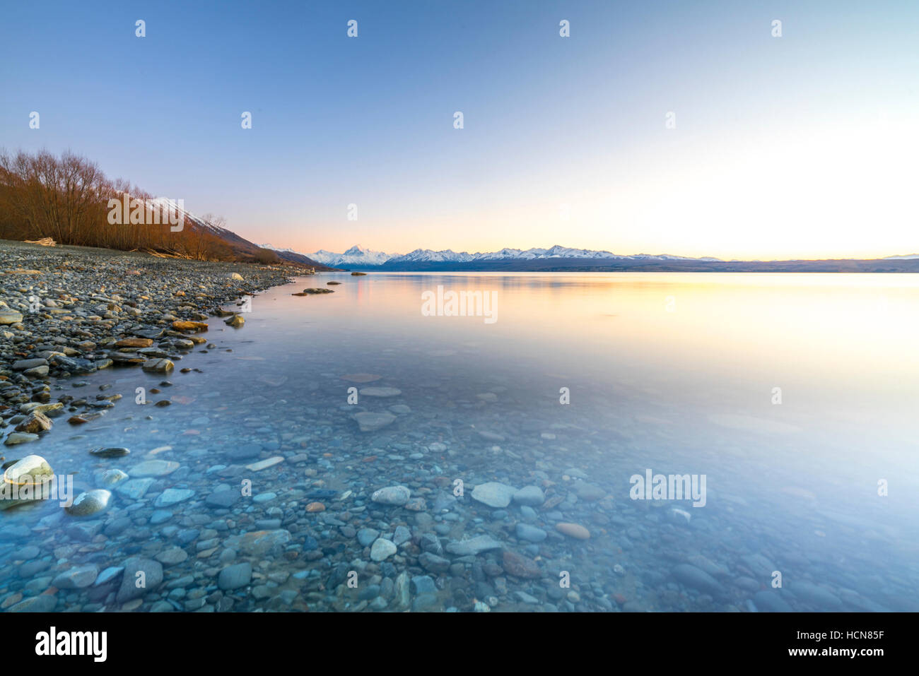 Stone lake with sunrise background Stock Photo - Alamy