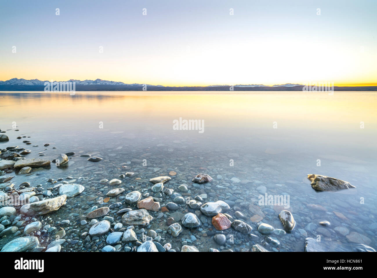 Stone lake with sunrise background Stock Photo - Alamy