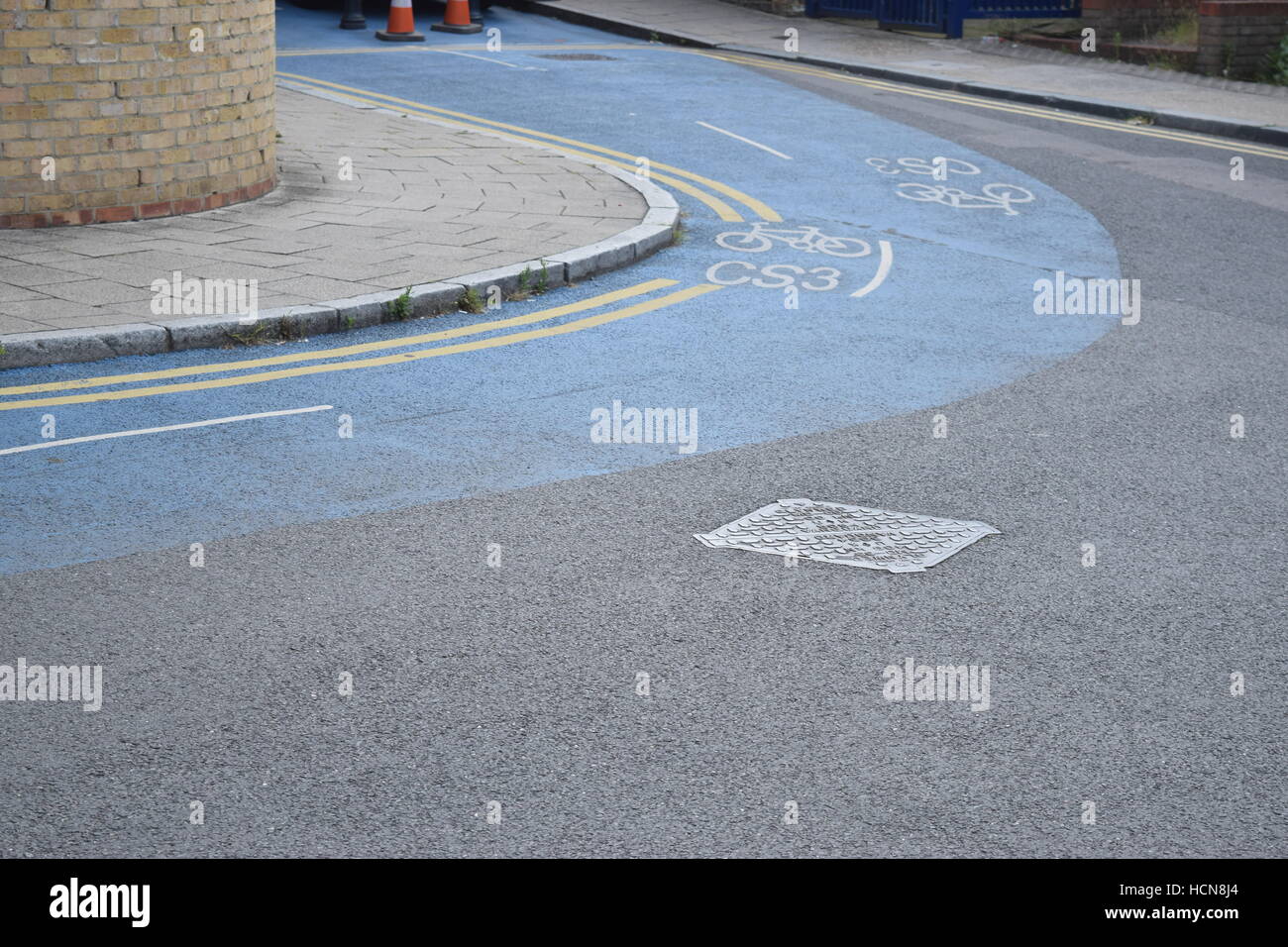 Bright blue bicycle lane on a sharp corner turn Stock Photo - Alamy