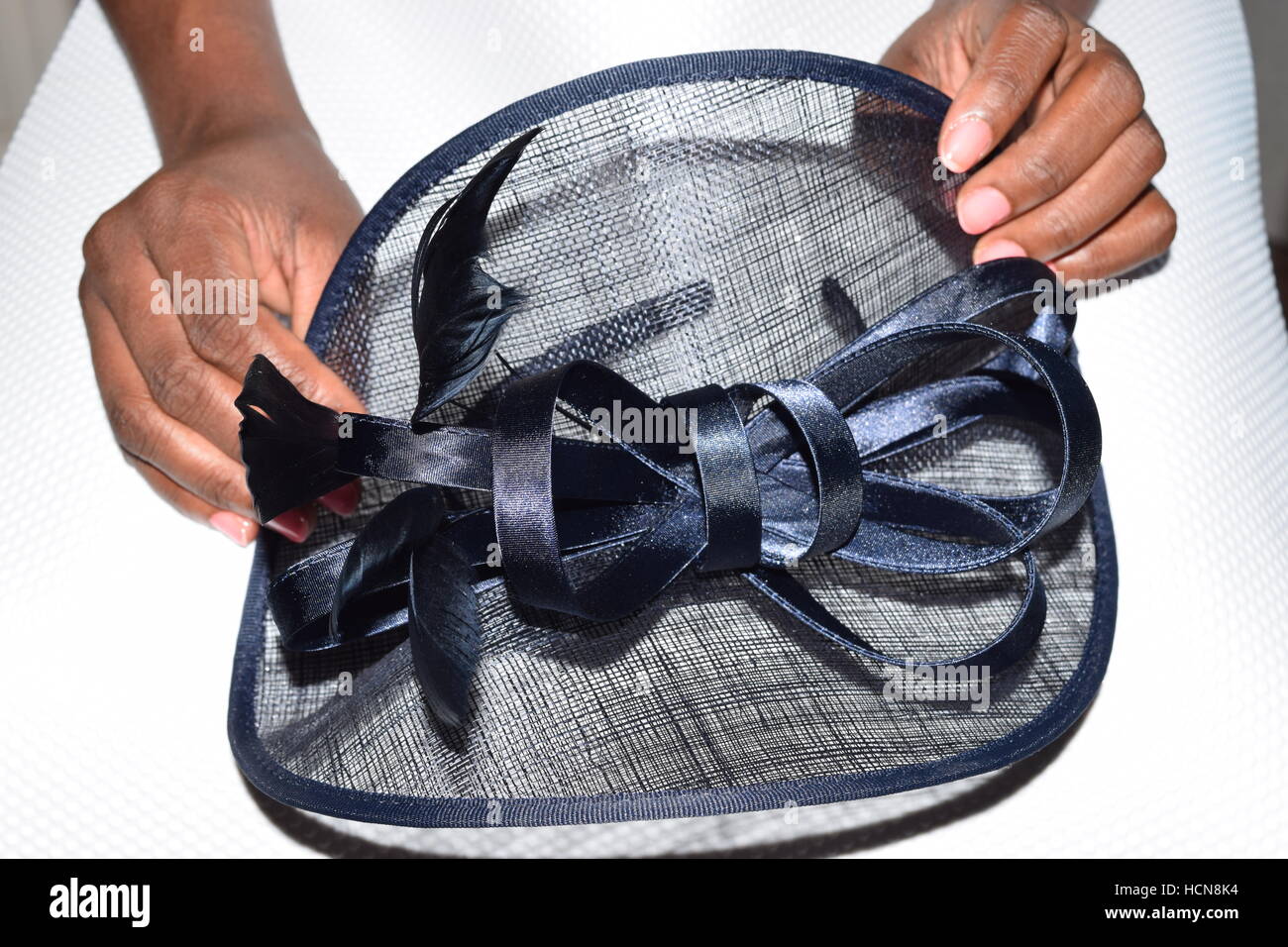 Beautiful female hands gently holding a fancy hat Stock Photo - Alamy