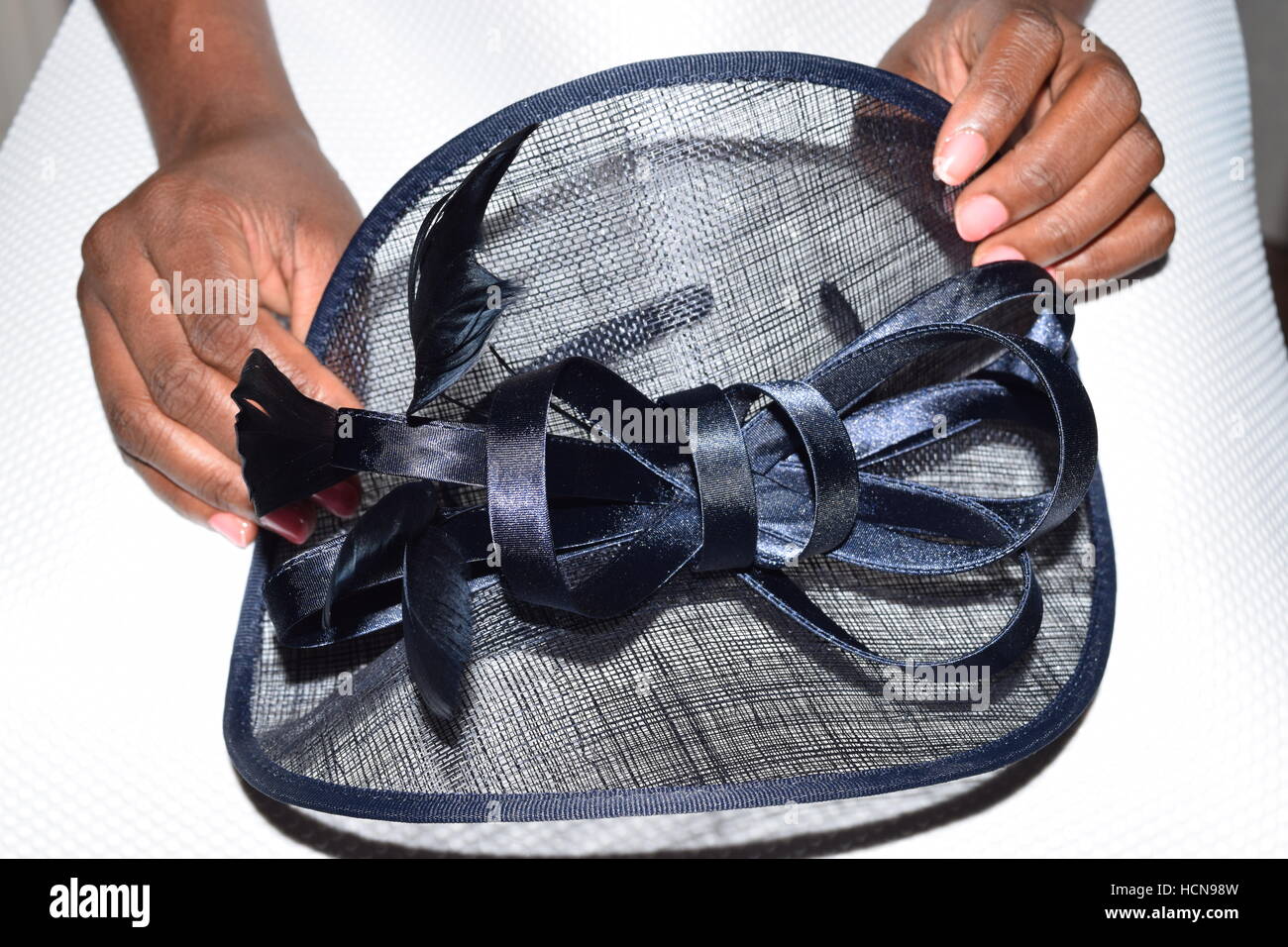 Beautifully painted female hands clutching a fancy fascinator Stock ...